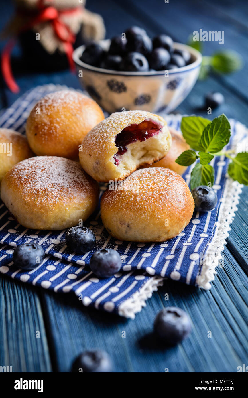 Fresh baked buns filled with blueberry jam Stock Photo - Alamy