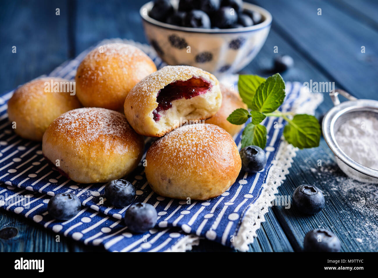 Fresh baked buns filled with blueberry jam Stock Photo - Alamy