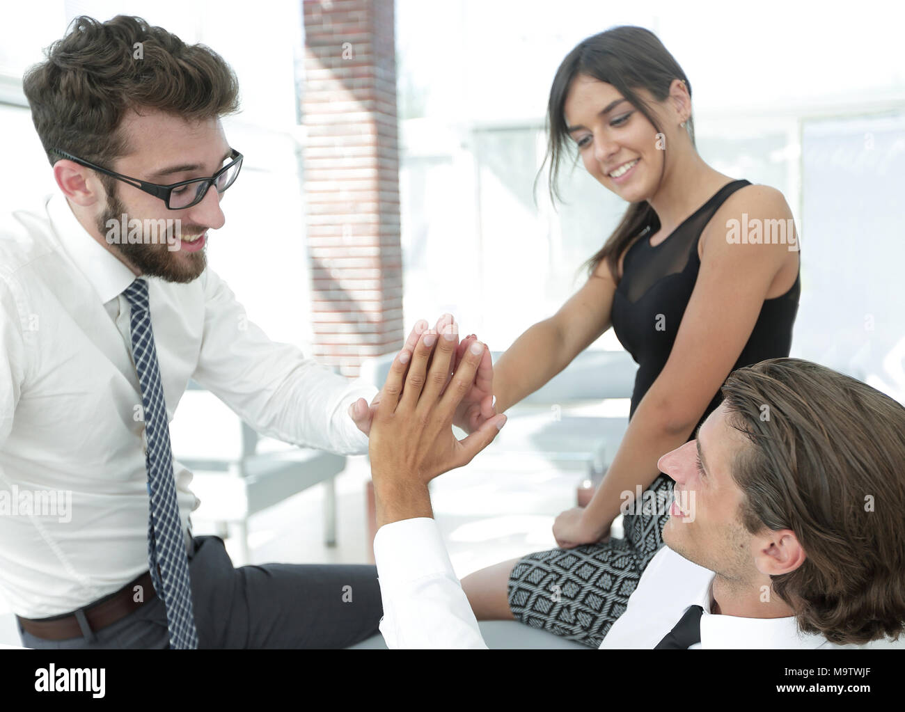 members of the business team give each other high five Stock Photo - Alamy