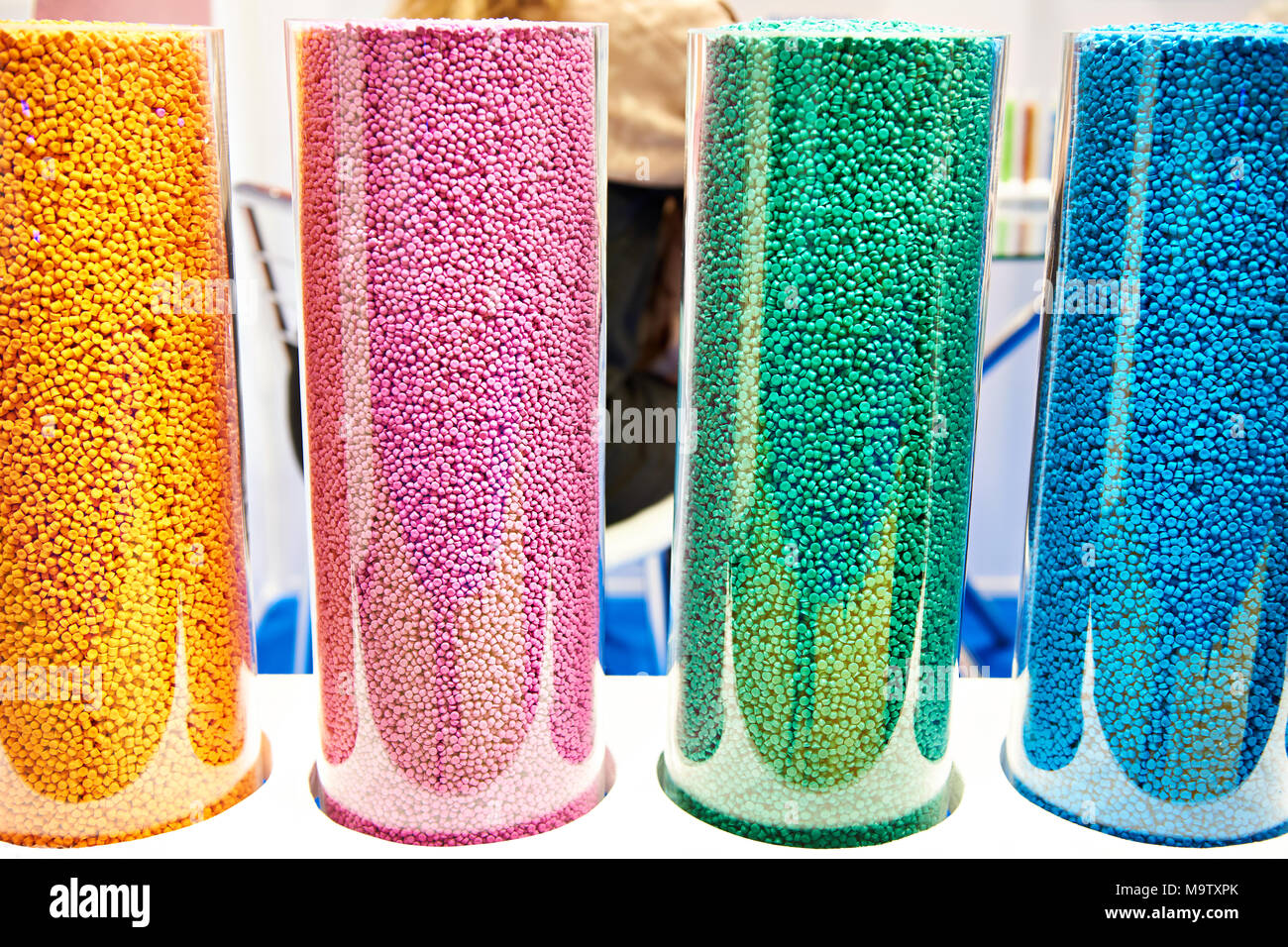 Colorful plastic granular polymer in glass flasks Stock Photo - Alamy
