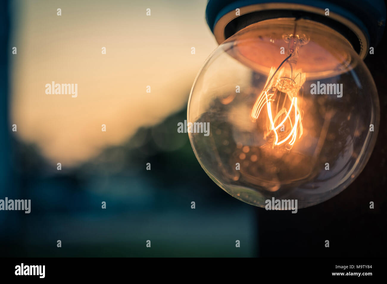 Glowing antique filament light bulb Stock Photo - Alamy