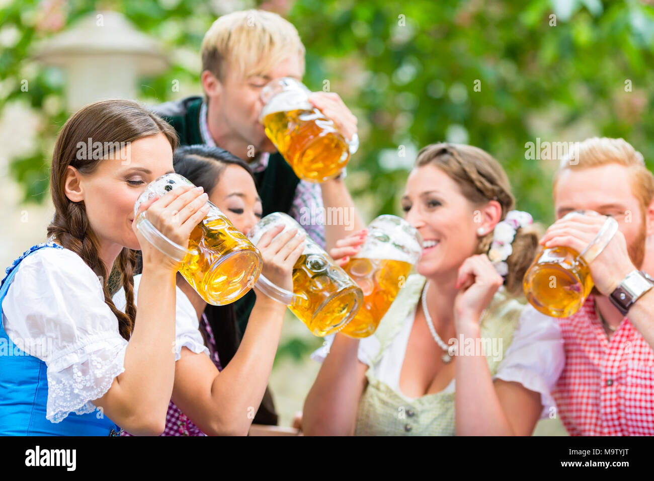 Friends drinking beer in beer garden Stock Photo - Alamy