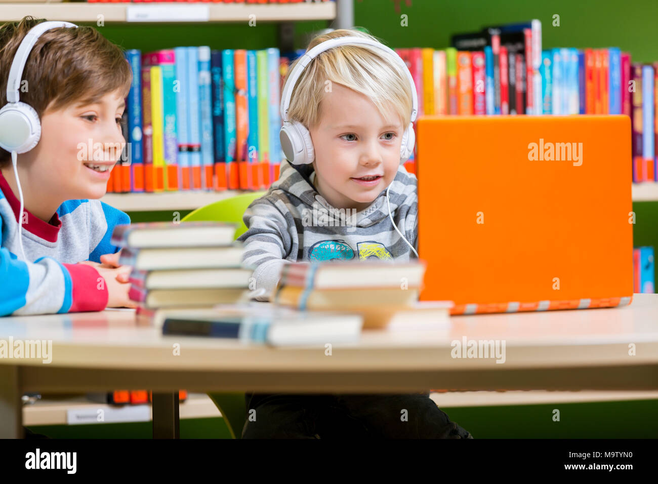 Child headphones child reading book hi-res stock photography and images ...