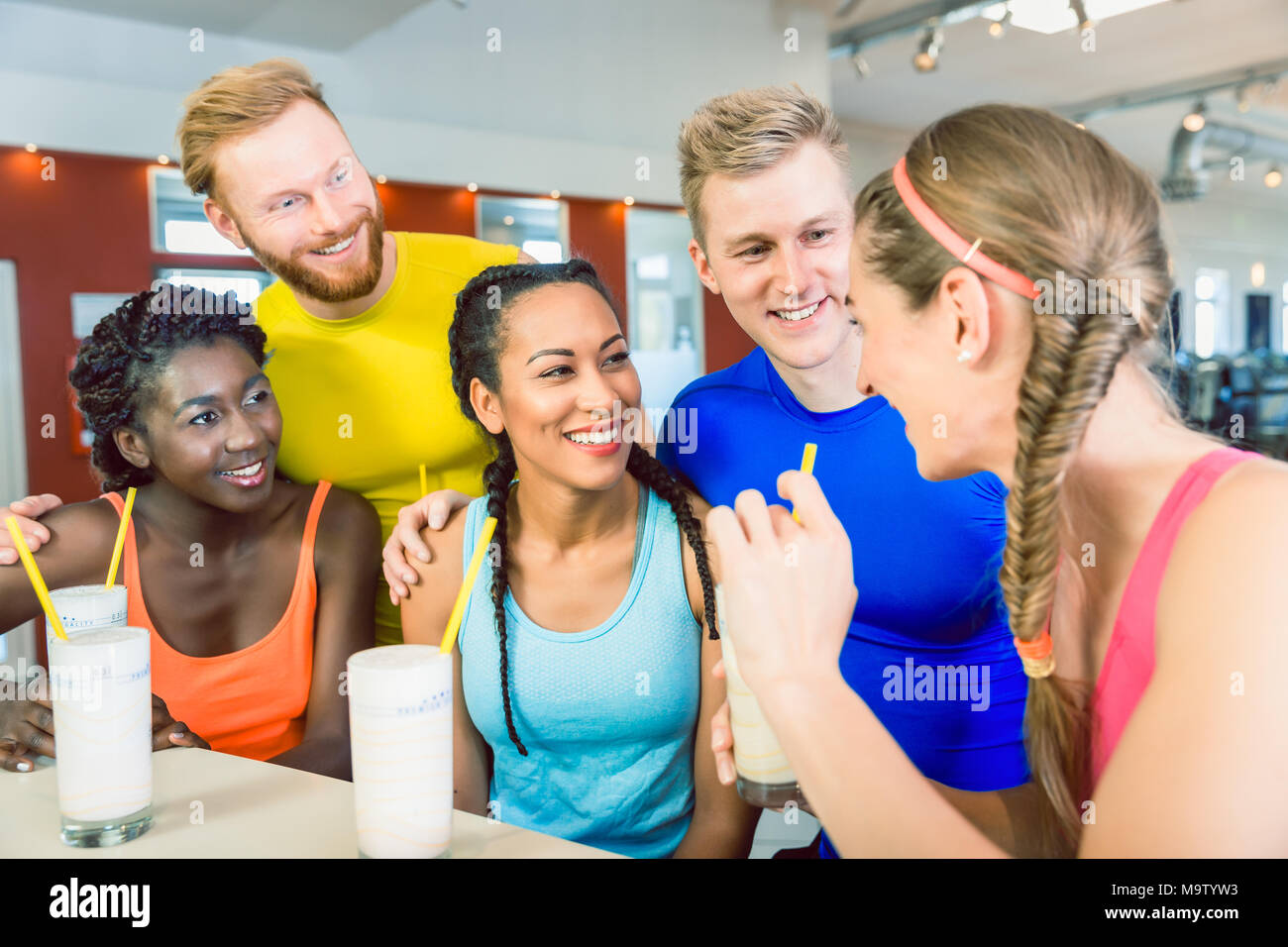 Multi-ethnic group of cheerful friends drinking protein shakes Stock ...