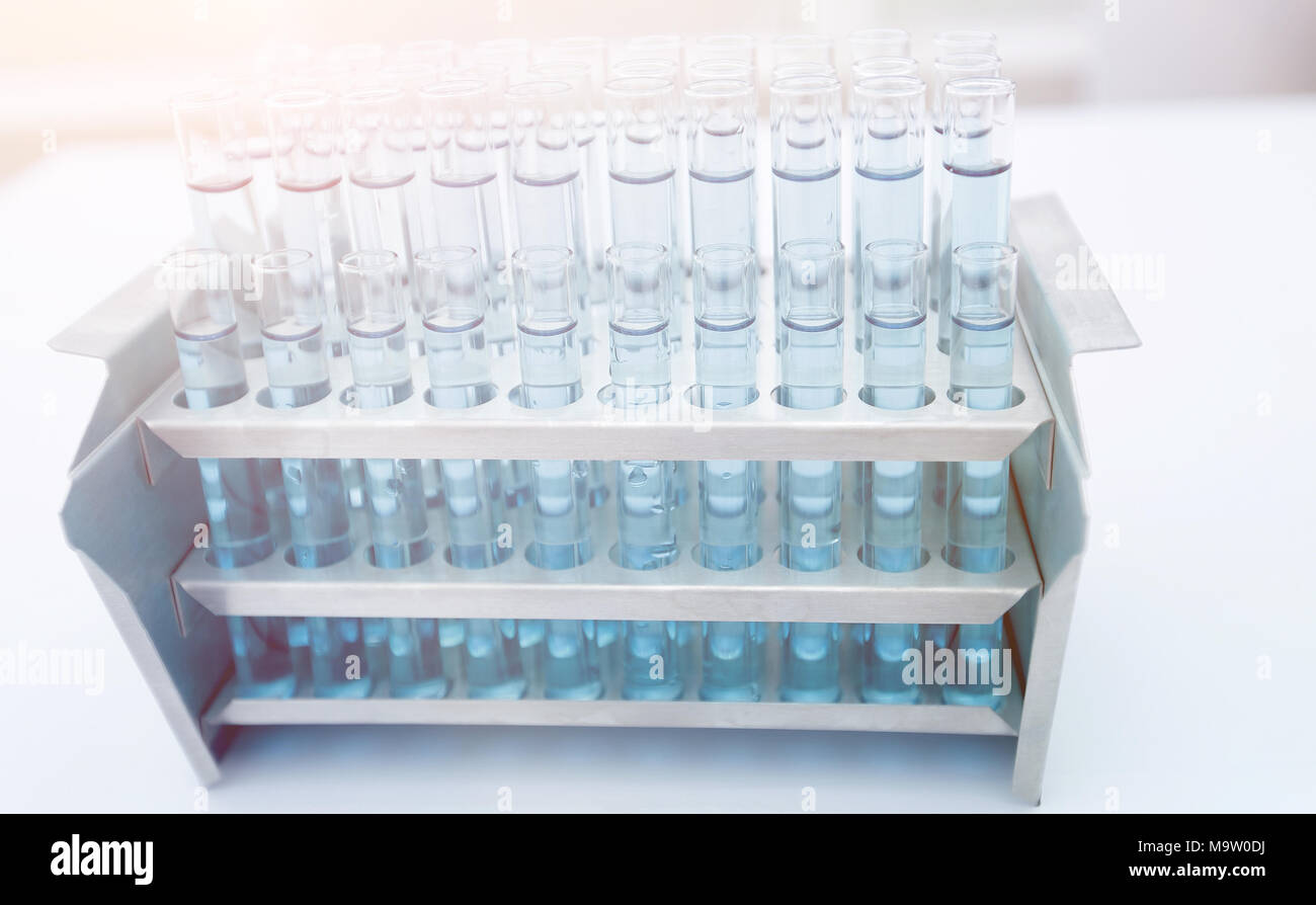 Blue water in a transparent test-tube on light background Stock Photo ...