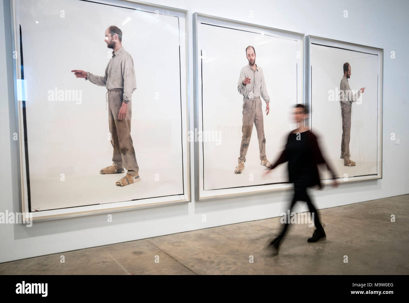 Walks past a work titiled oi by artist gavin turk hi-res stock ...
