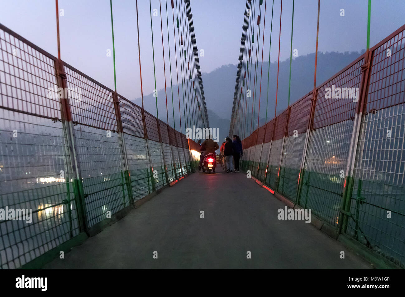 People crossing Laxman Jhula suspension bridge on river Ganga. night ...