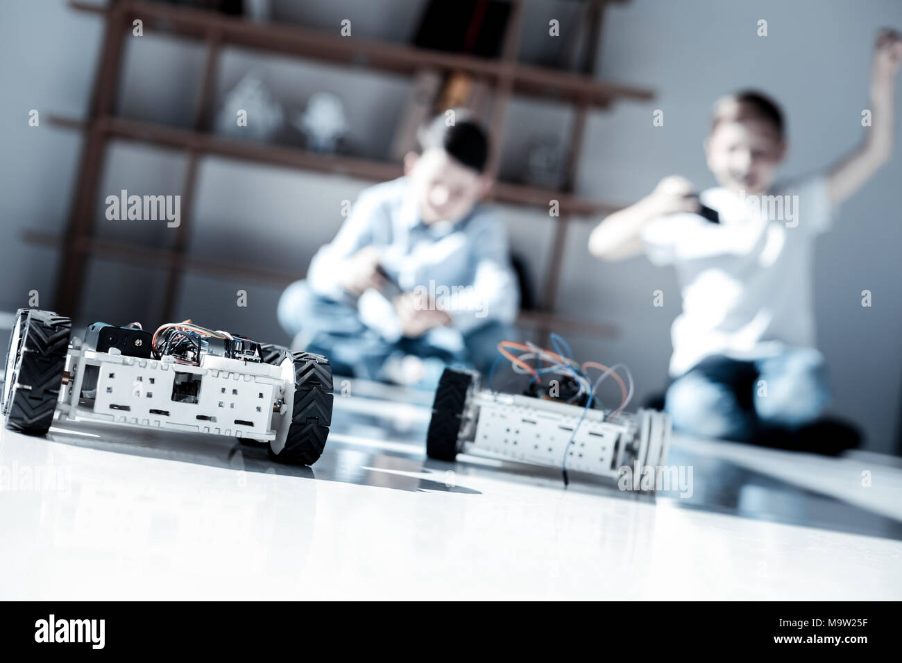 Children playing with their new robots at home Stock Photo - Alamy