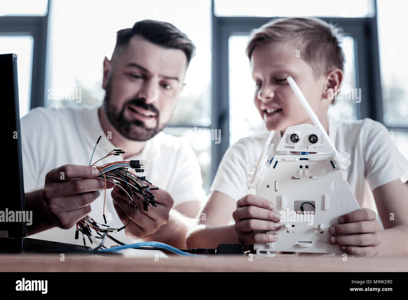 Teacher and student working on impressive robotic machine Stock Photo ...