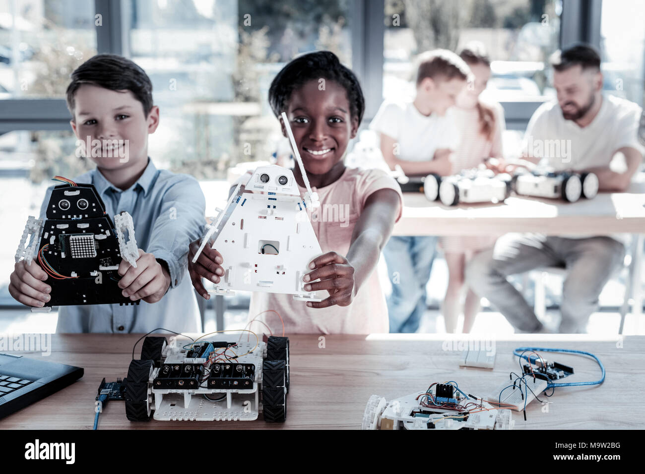 Adorable youngster showing their robotic machines Stock Photo - Alamy