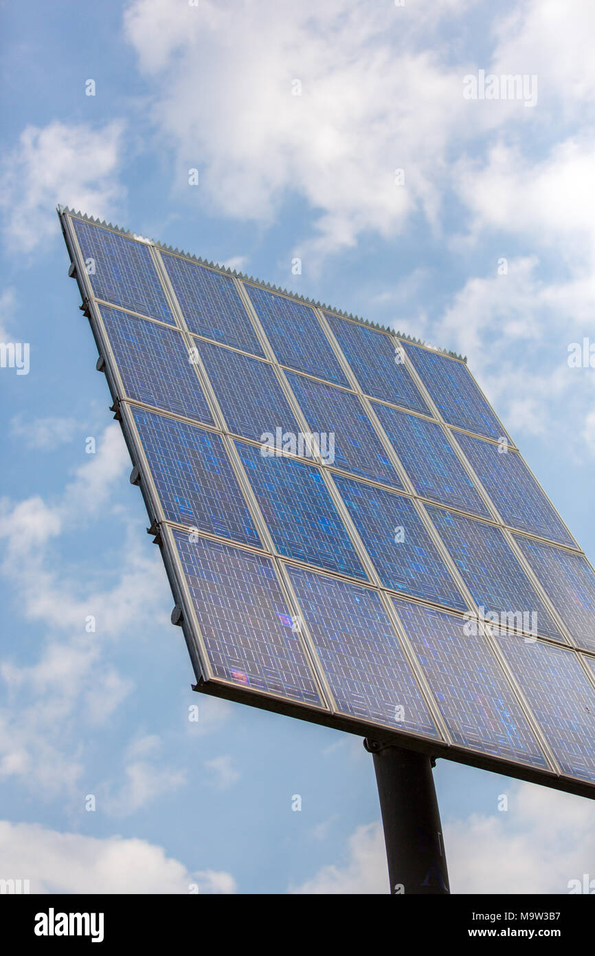 Pole with 20 solar panels collecting sunlight in a blue sky Stock Photo ...