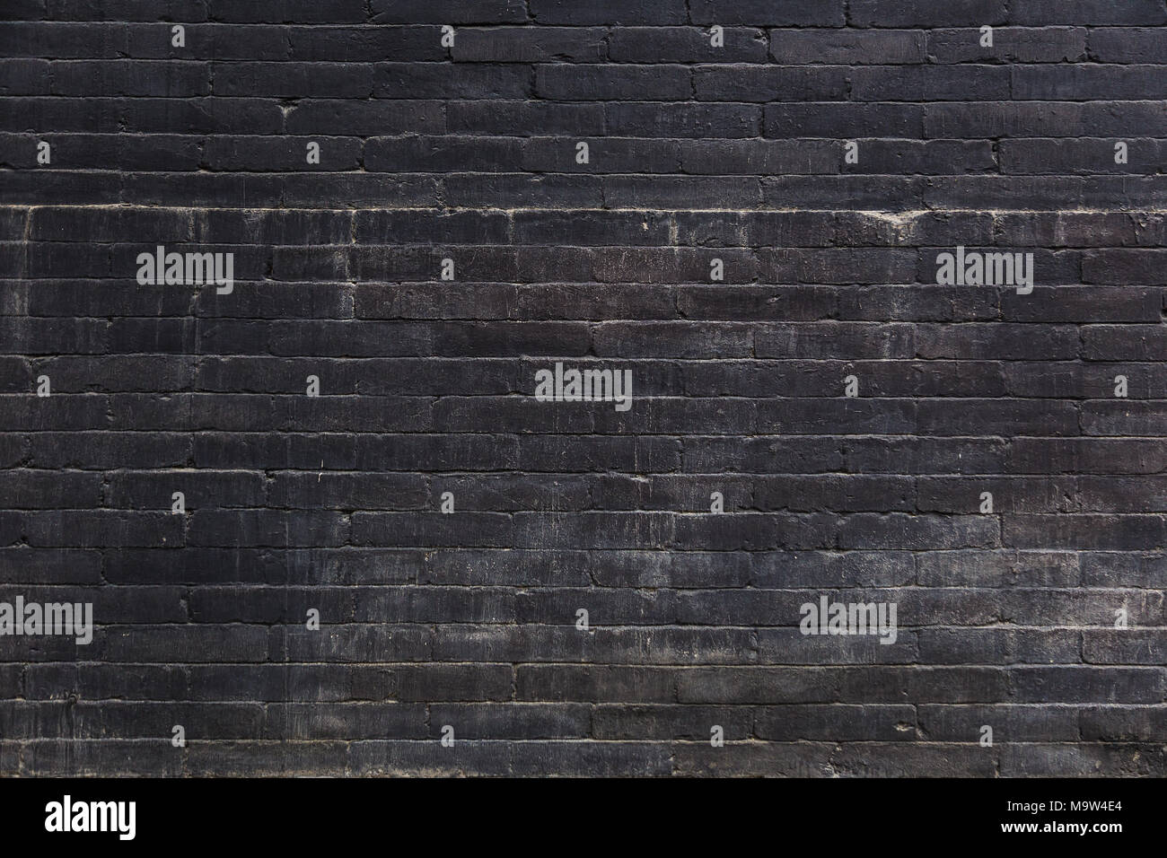 Old and rustic dark brick wall Stock Photo - Alamy