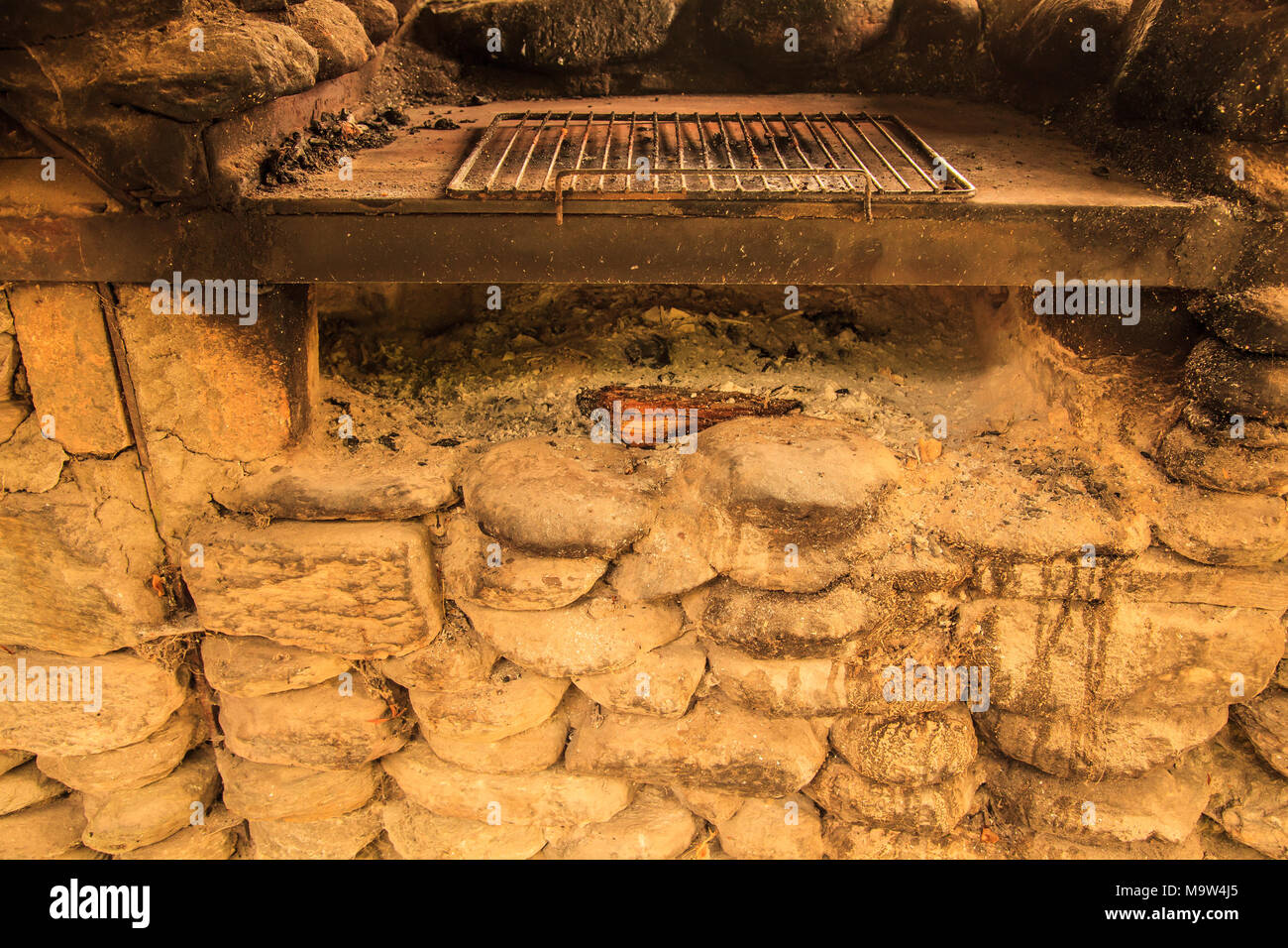 A stone building with a stone fireplace in a camping site, park or ...