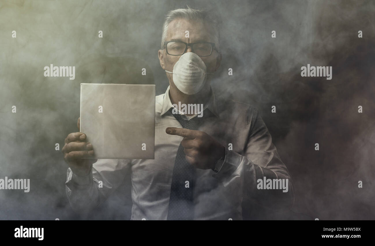 Businessman wearing a mask and polluted air, he is holding a blank sign ...