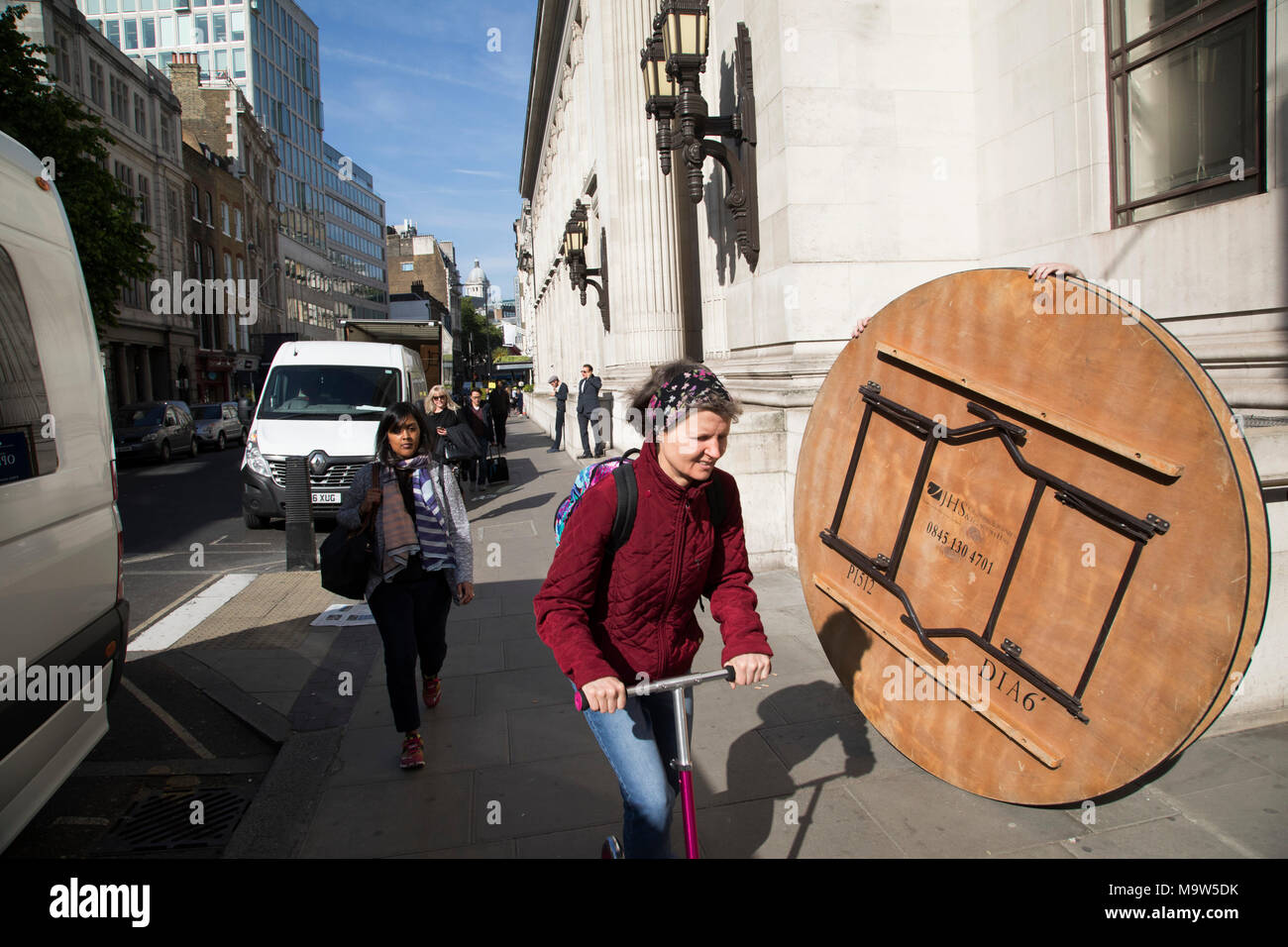 Men rolling large dining tables following an event at Freemasons Hall ...