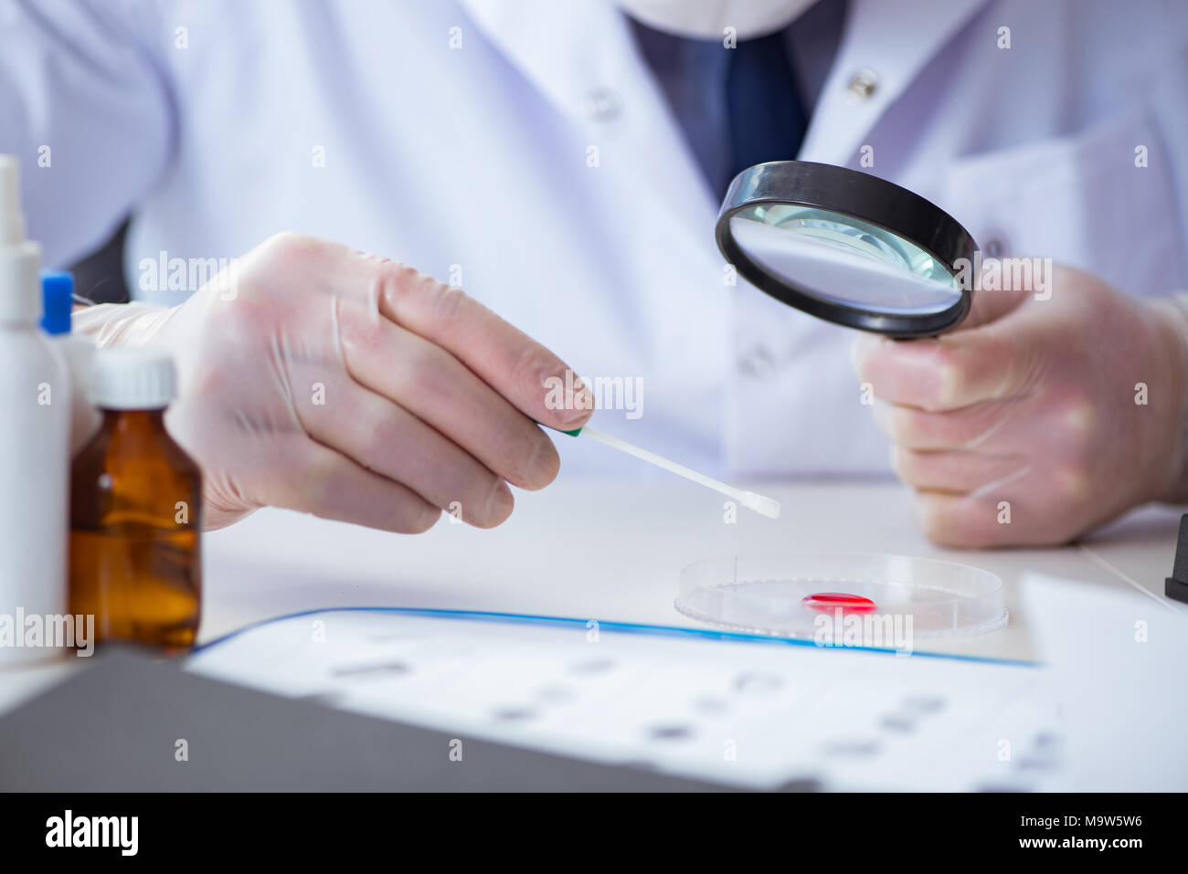 Drug synthesis lab experimentnig with pills Stock Photo - Alamy
