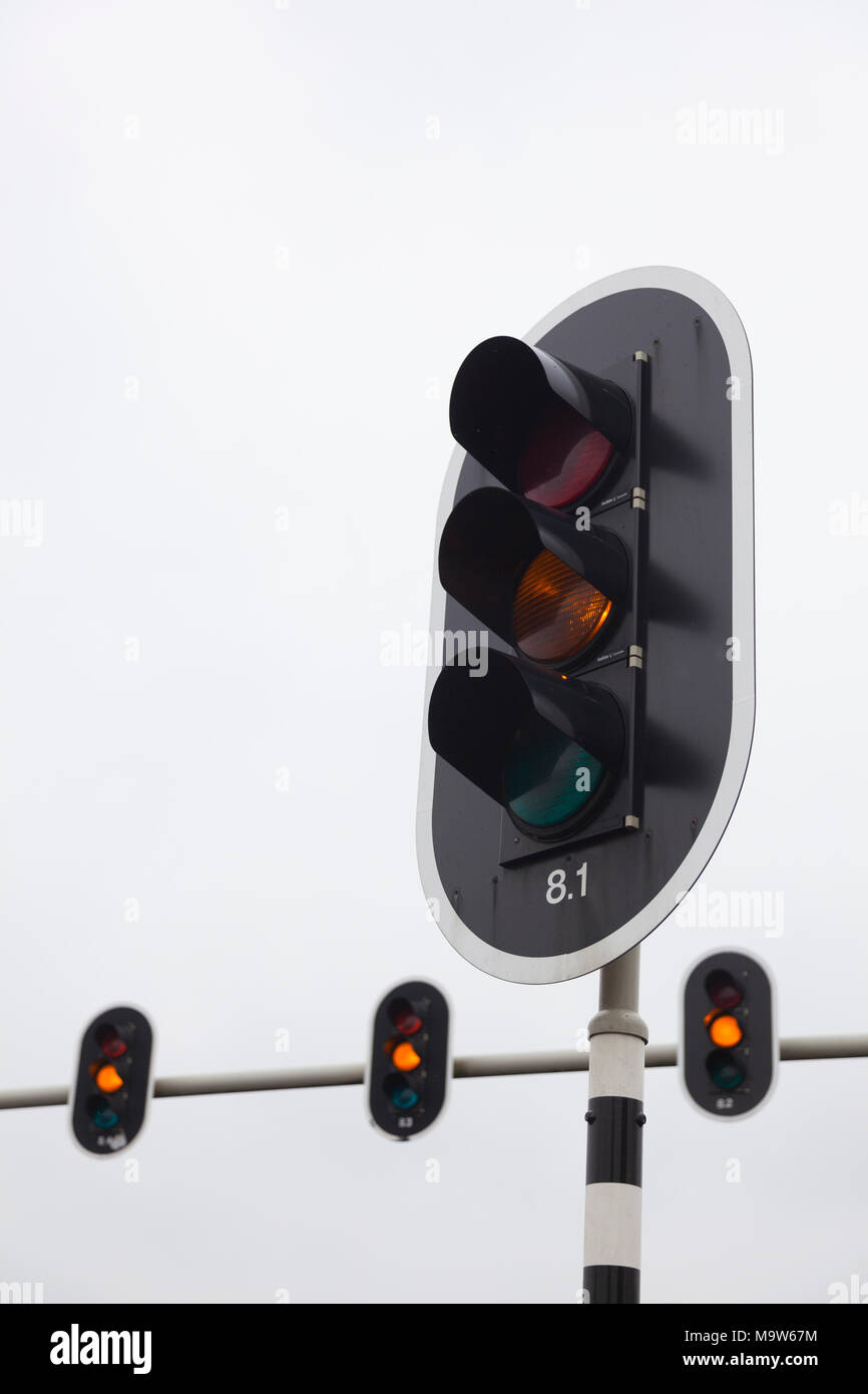 orange traffic lights and overcast sky Stock Photo - Alamy