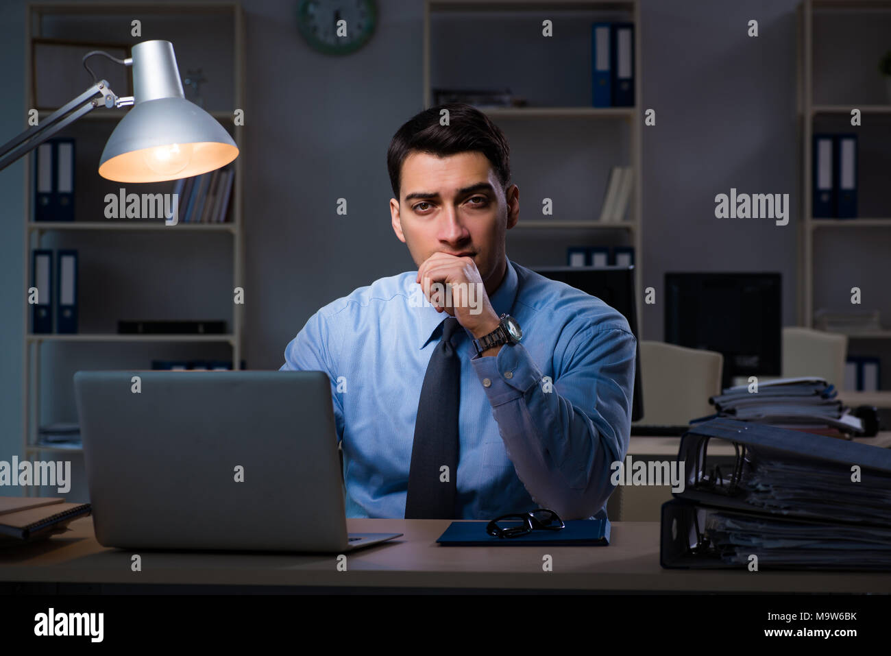 Businessman working late at night in overtime shift Stock Photo - Alamy