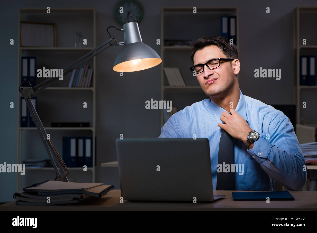 Employee working late at night at important report Stock Photo - Alamy
