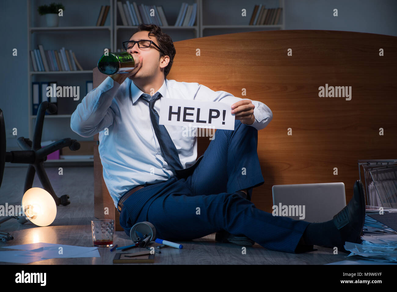 Employee asking for help and drinking under stress and despair Stock ...