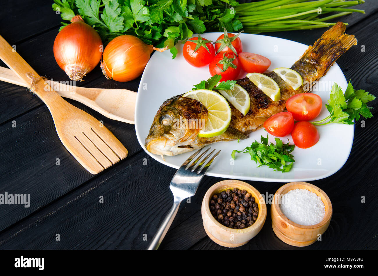 Fried fish served on the plate Stock Photo - Alamy