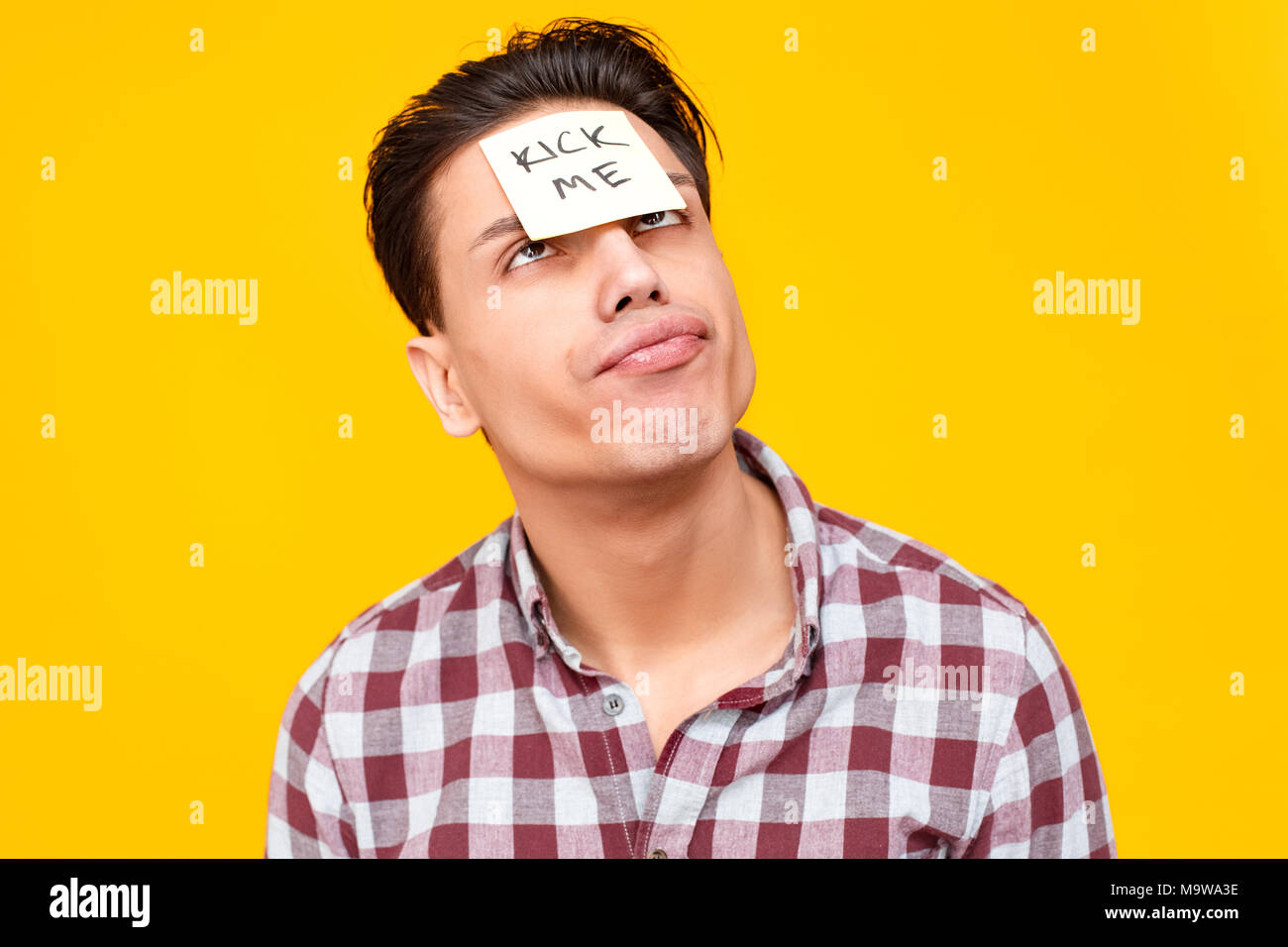 Man looks at the sticker that's on his head. Fool's day emotions and ...