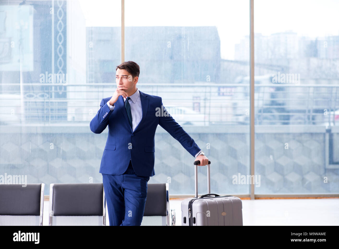 Businessman waiting at the airport for his plane in business class Stock Photo - Alamy