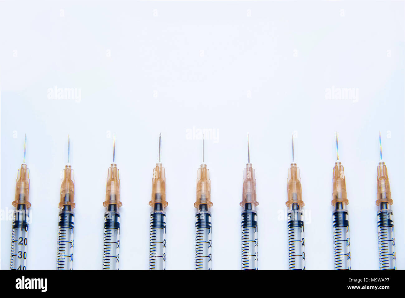 A series of insulin syringes with needles close-up isolated on white ...