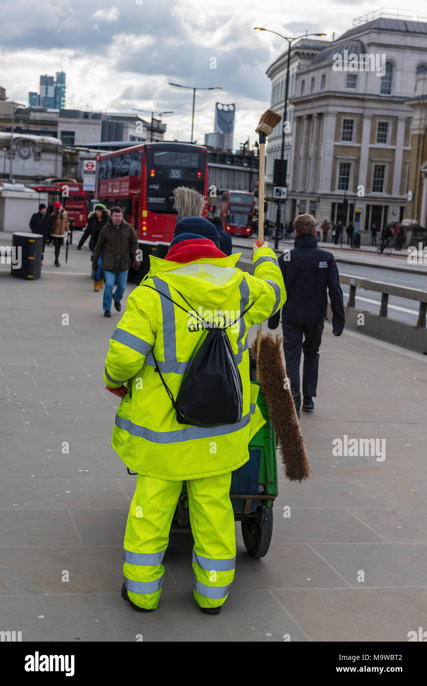 a street cleaner in central london on the bridge in southwark. working ...