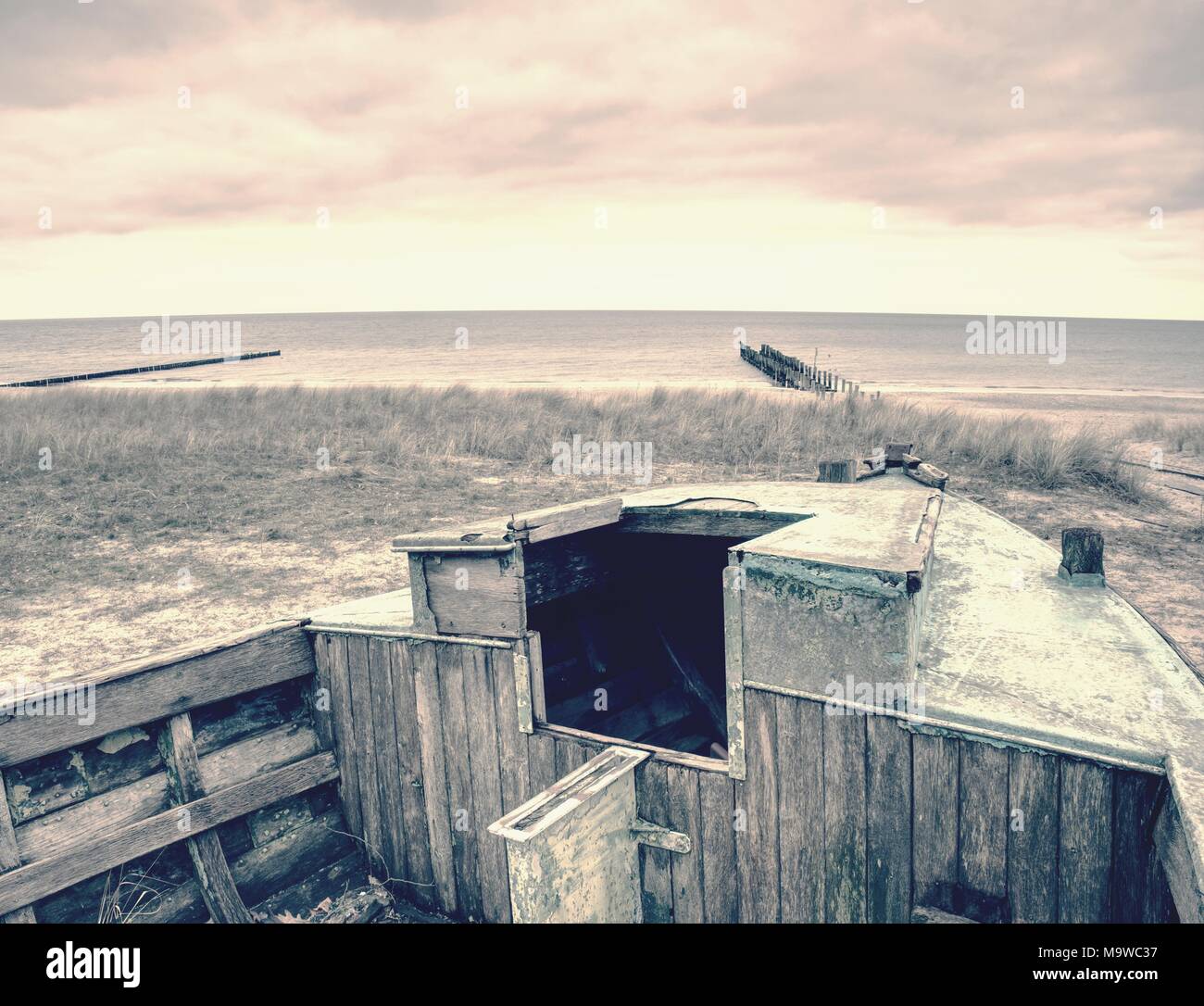 Wrecked fishing boat on old dry grass. Abandoned wooden ship with ...