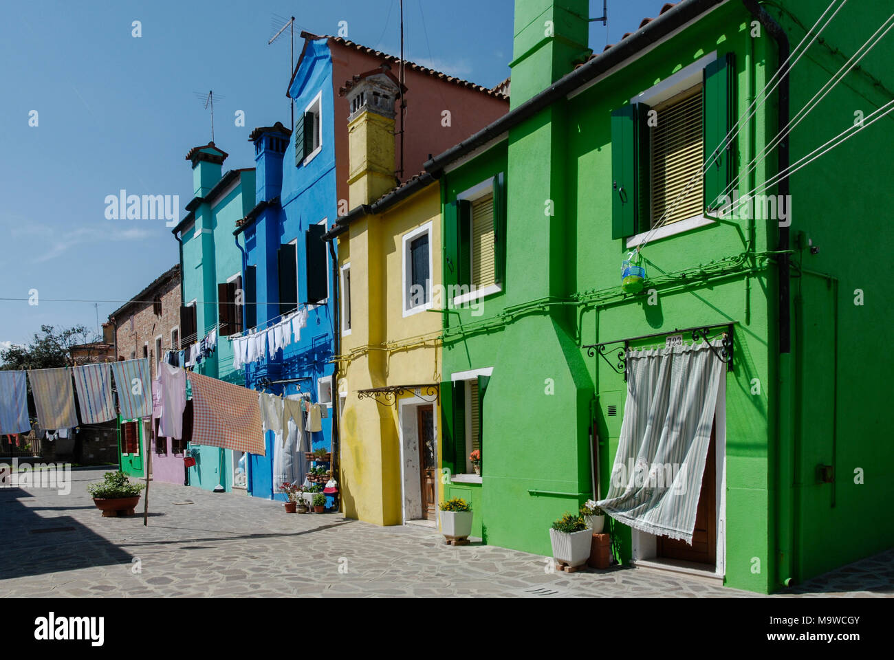 BURANO, ITALY - APRIL 18, 2009: Street with colorful buildings in ...