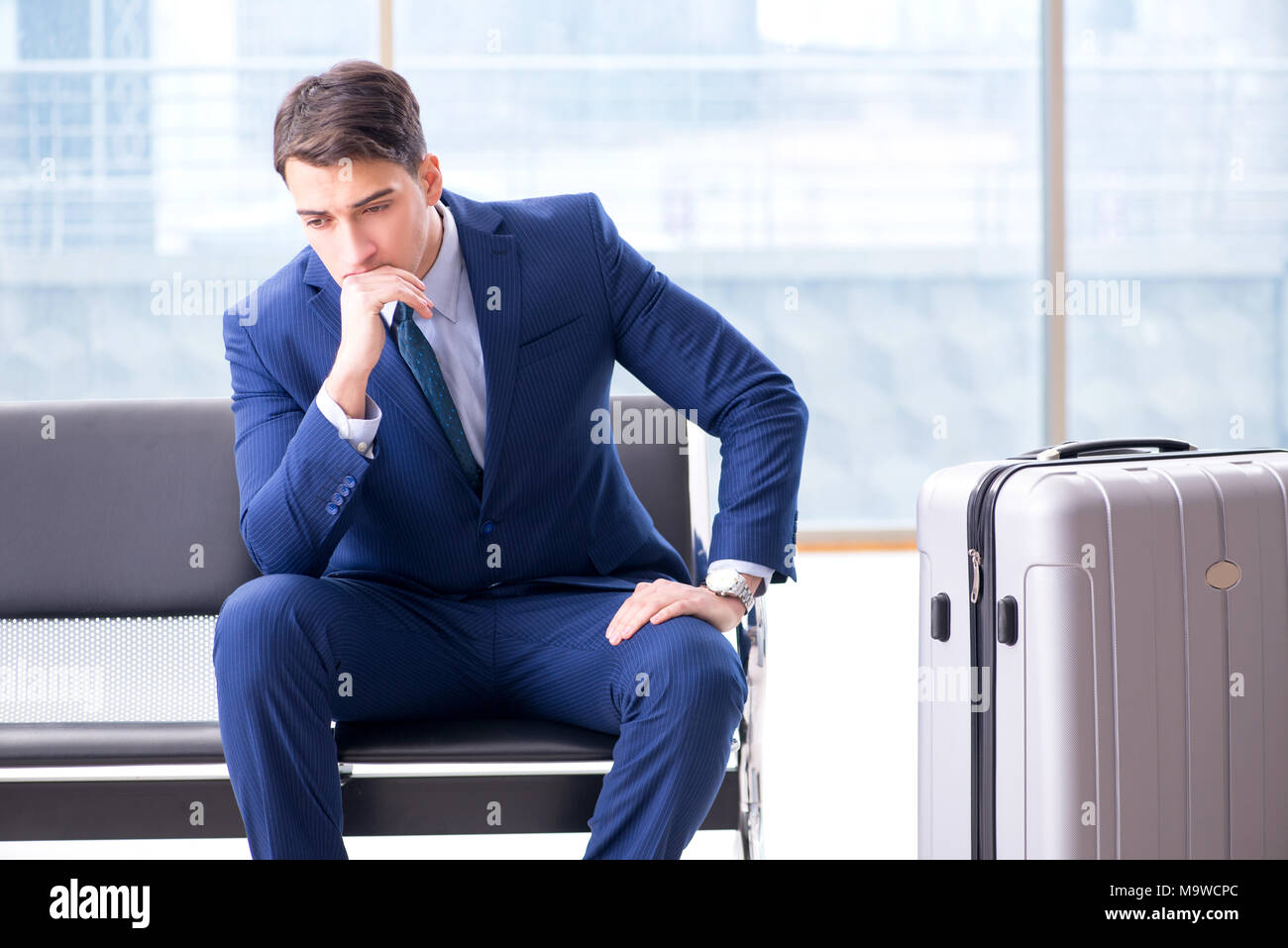 Businessman waiting at the airport for his plane in business class Stock Photo - Alamy