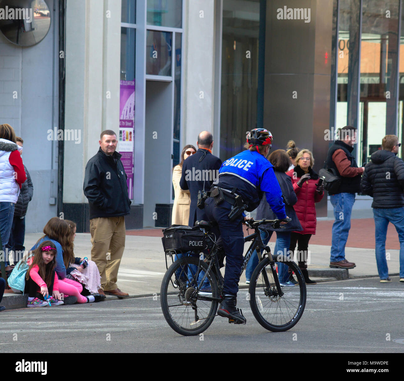Police on bicycle controlling crowd at event Stock Photo - Alamy