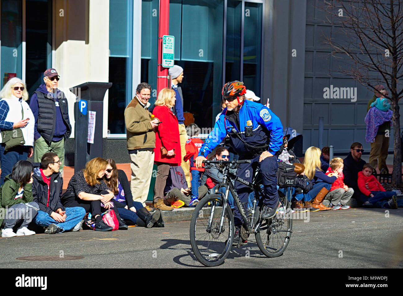 Police on bicycle controlling crowd at event Stock Photo - Alamy
