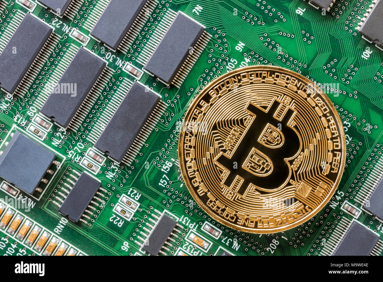 A photo of gold Bit coin on Printed Circuit Board, Bit coin and ...