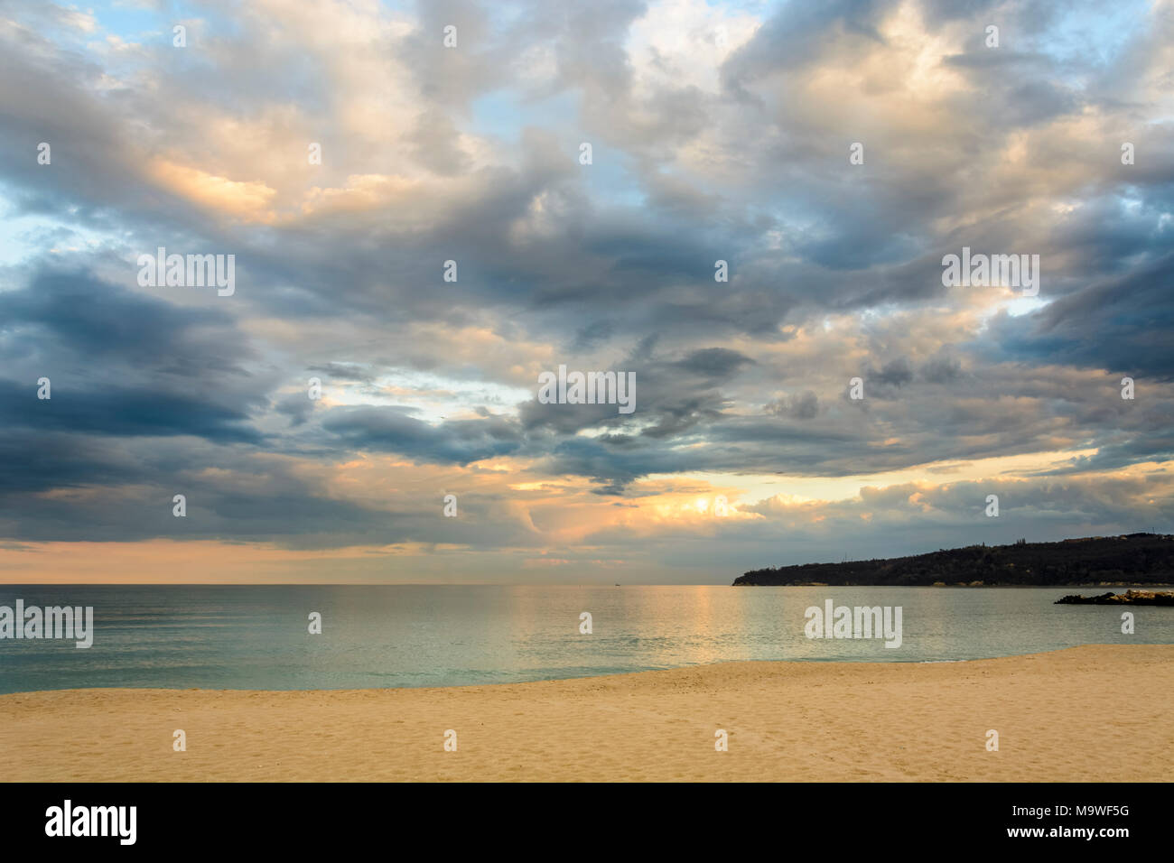Beach at sunset, Dramatic clouds over the sea Stock Photo - Alamy