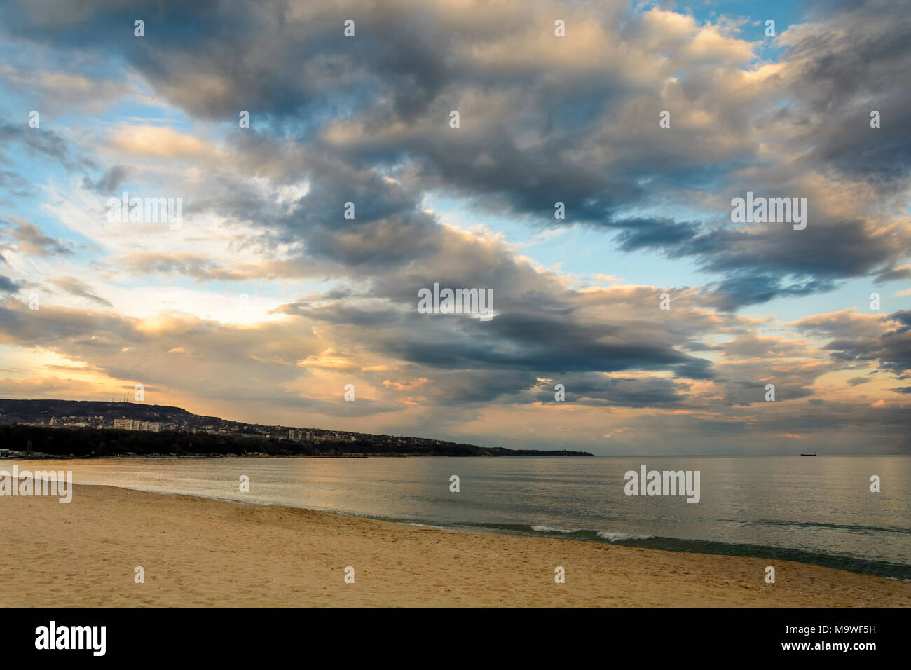 Beach at sunset, Dramatic clouds over the sea Stock Photo - Alamy