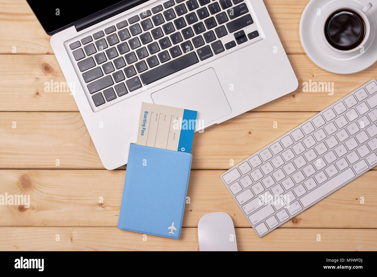 Computer keyboard, passport, plane model and credit card on wooden ...