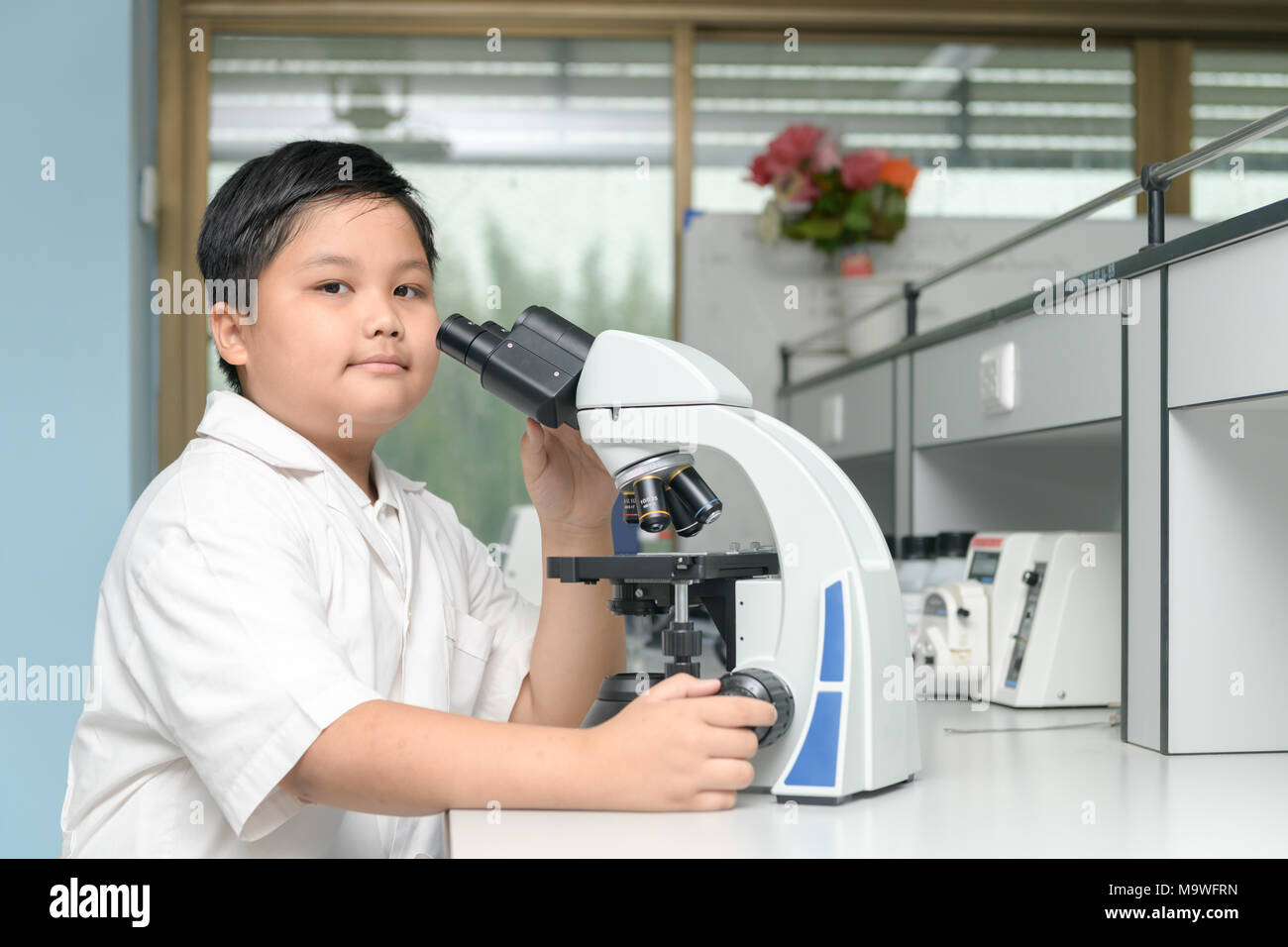 scientist boy working with microscope in laboratory, science and ...