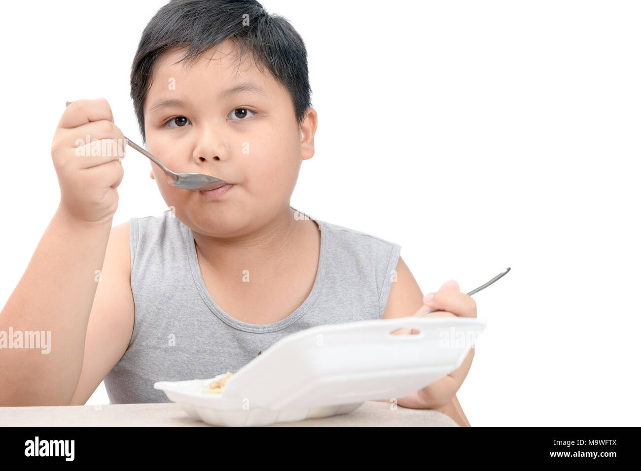 Obese fat boy eating fried rice in foam box isolated on white ...
