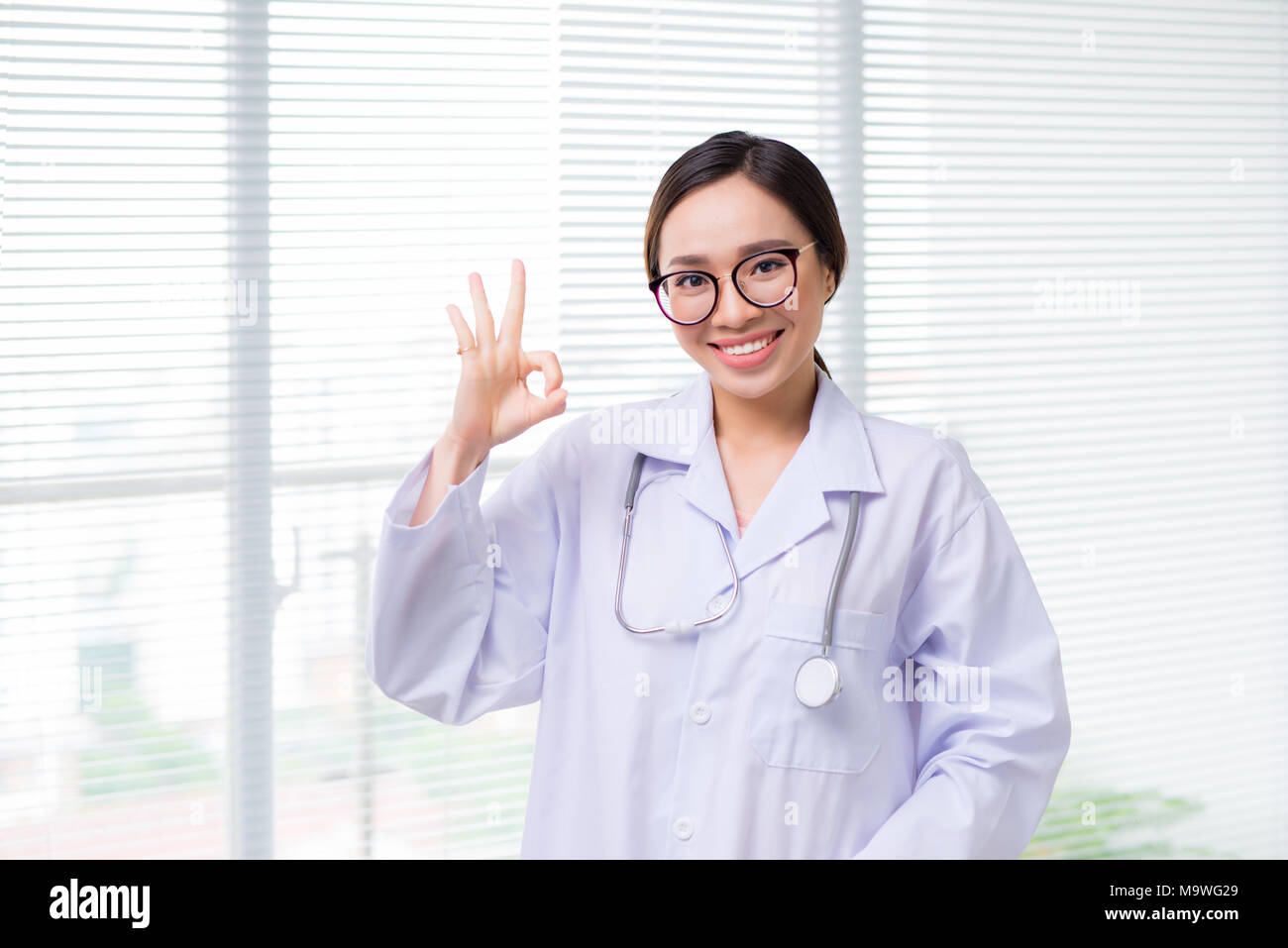 Female doctor hands with thumbs up gesture Stock Photo - Alamy