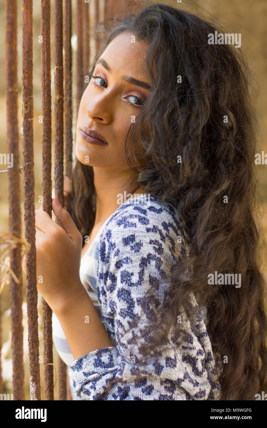 Girl behind bars hi-res stock photography and images - Alamy