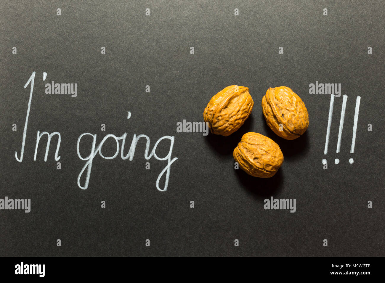 Concept of the phrase I'm going nuts with brown nuts and white hand ...