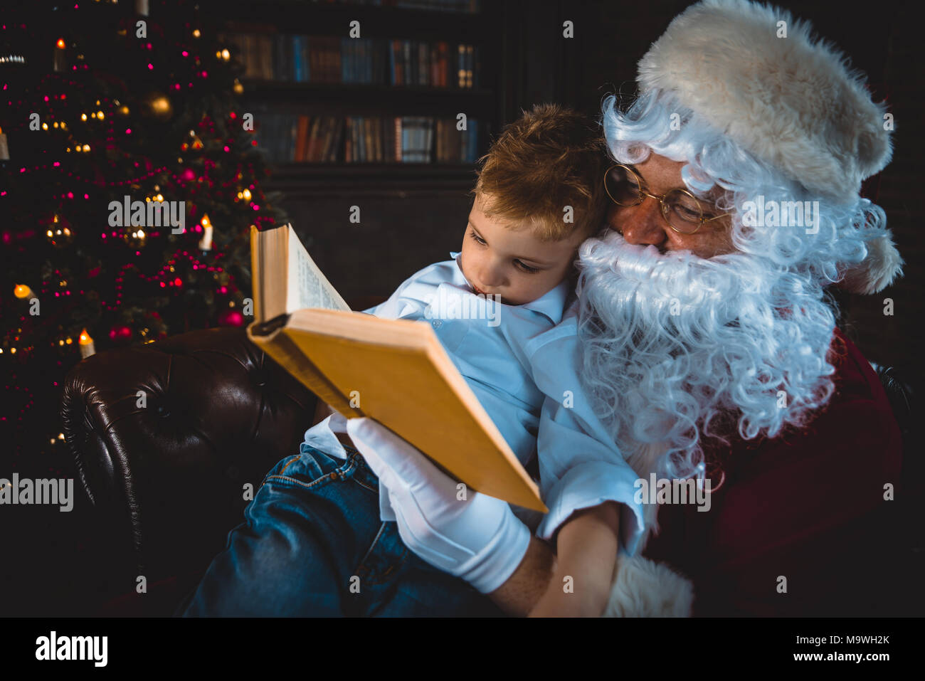 Santa claus reading christmas story hi-res stock photography and images ...