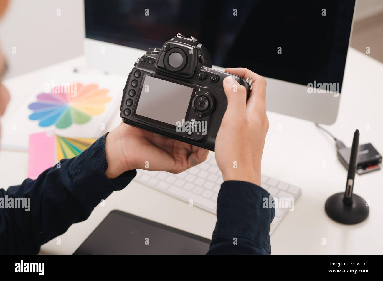 Photographer working at desk in modern office Stock Photo - Alamy