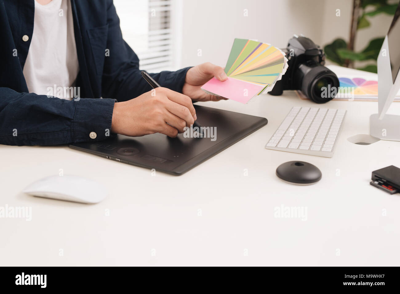 Male photographer at the studio doing some photo retouching Stock Photo ...