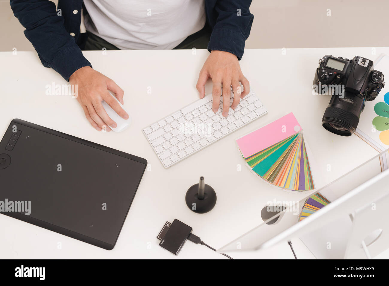 Male photographer at the studio doing some photo retouching Stock Photo ...