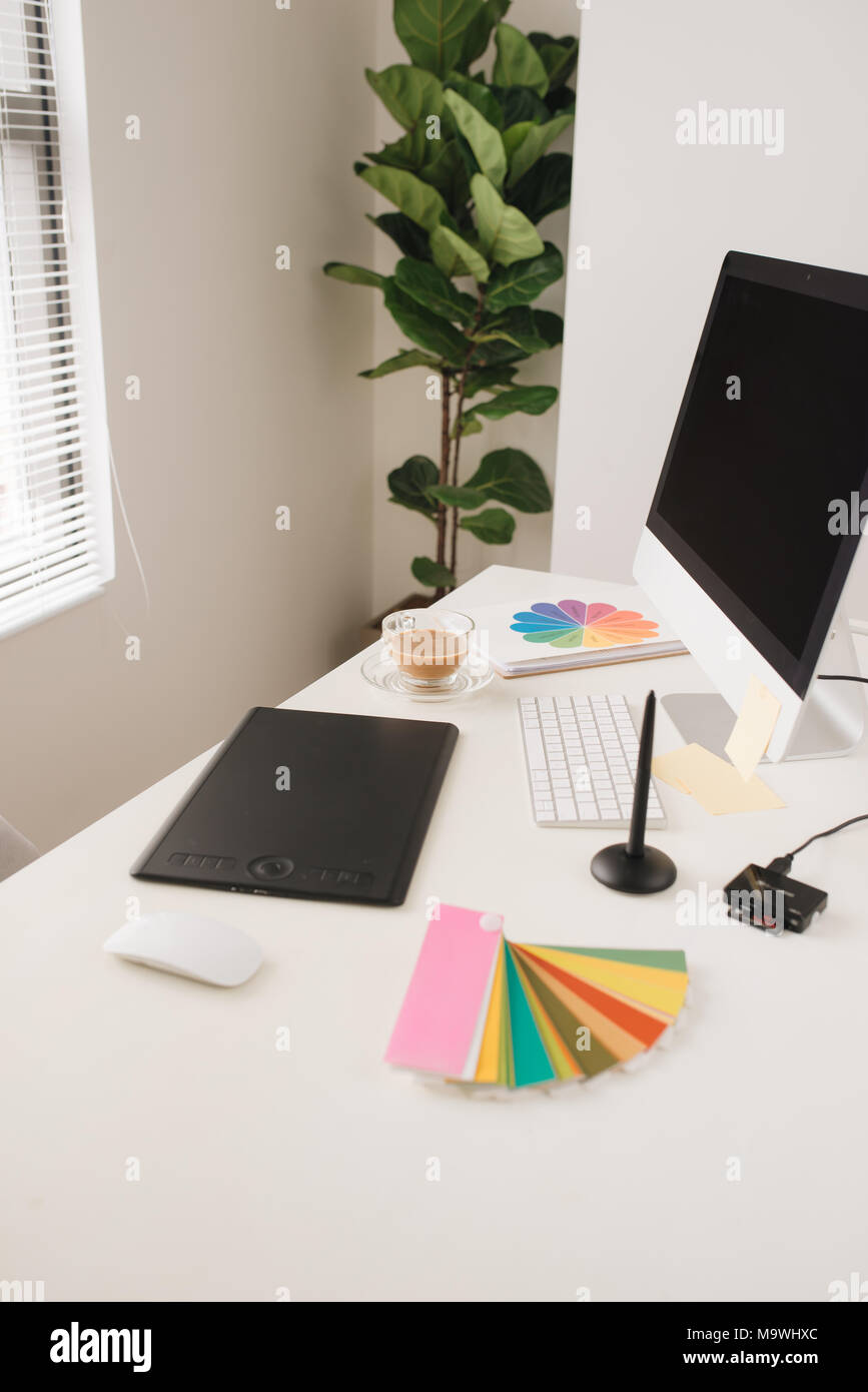 Creative designer workplace with desktop computer, stylus and tablet ...
