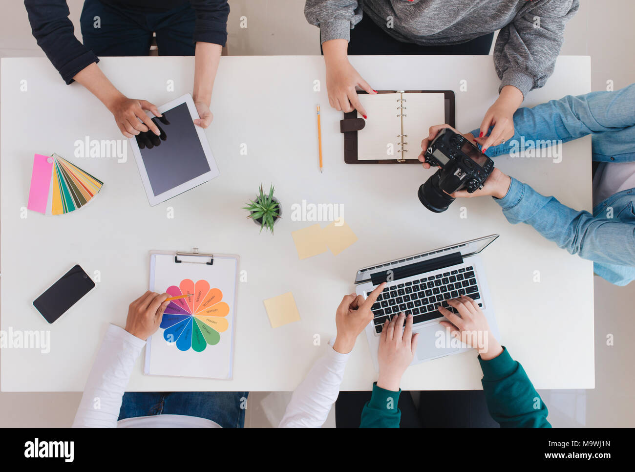 Young creative team having a meeting in creative office - teamwork ...