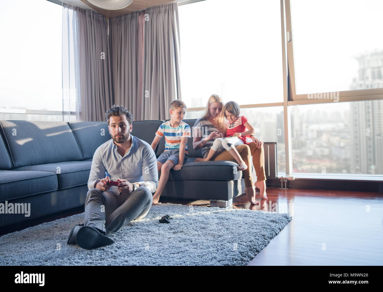 Happy family. Father, mother and children playing a video game Father ...